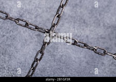 Two metal chains crossed on dark background Stock Photo - Alamy