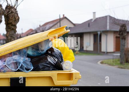 Overfilled trash dumpster full with mixed trash on a street Stock Photo ...