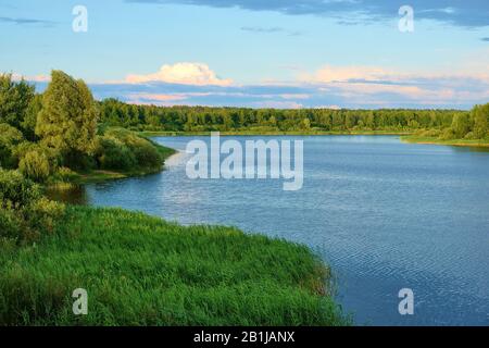 A beautiful calm river against the cloudy sky - perfect for background ...