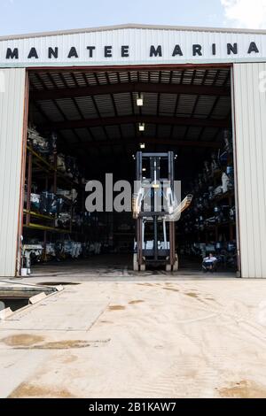 A Wiggins Marina Bull Lo Pro forklift is used to stack boats high ...