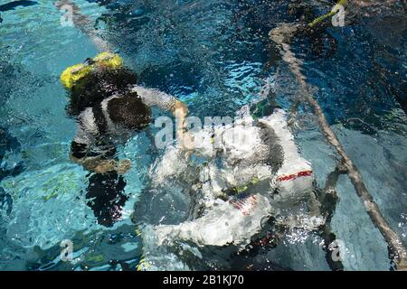 Veteran astronaut Anne C. McClain suits up in NASA's Neutral Buoyancy ...