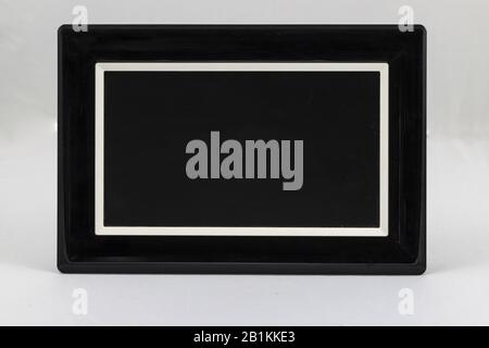 Isolated digital picture frame for table or shelf. Perspective view of ...