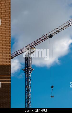 Construction project with crane lifts materials off of Flat Bed truck ...