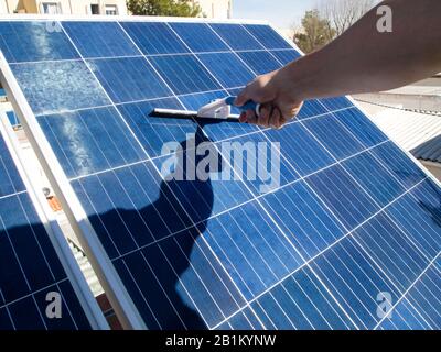 Hand cleaning solar panels Stock Photo - Alamy
