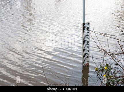 Water flood gauge depth marker and small river Stock Photo - Alamy
