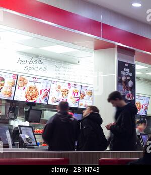 people stands in the Kentucky Fried Chicken (KFC) fast food restaurant ...