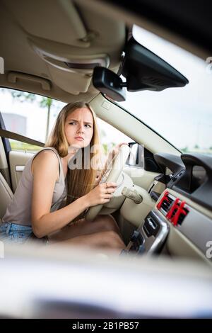 Cute female teen driver enjoying her freshly acquired driving license ...