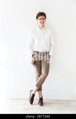 Curly haired handsome man posing in the studio Stock Photo - Alamy