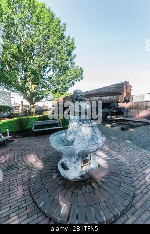 Sculpted Bust of Chief Seattle fountain and a rail car with wooden logs ...