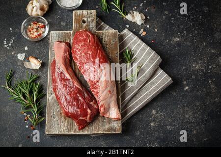Raw rump steak or top sirloin cap beef meat steaks on butcher table ...