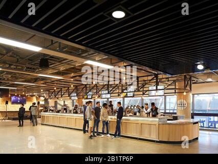 Pub-style feature bar for fans in concourse with window wall to stadium ...