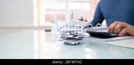 Hands of businessman calculate tax with calculator while laptop ...