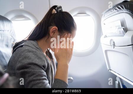 Young Woman Suffering From Airsickness In Airplane Stock Photo - Alamy