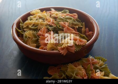 loop pasta, bright natural colors, basil green and red tomatoes, with ...