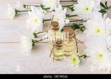Bottles of essential oil and cream on table Stock Photo - Alamy