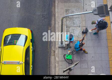 Street performer on a sidewalk of Bangkok, Thailand, playing a ...