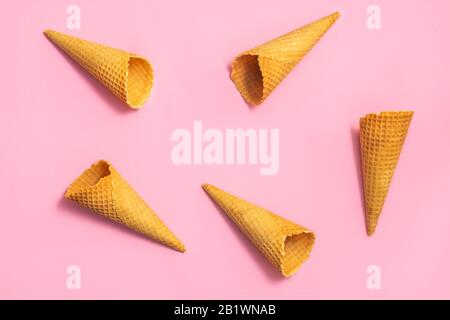 Waffle ice cream cone flat lay top view on dark black wooden background ...