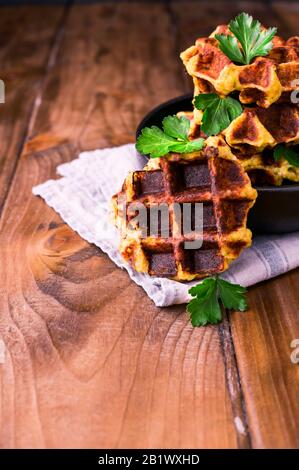 vegetable waffles cooked with herbs in a plate on a wooden table Stock ...
