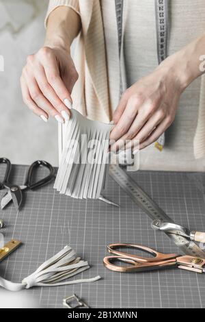 Craftswoman working creating handmade clothing in workshop Stock Photo ...
