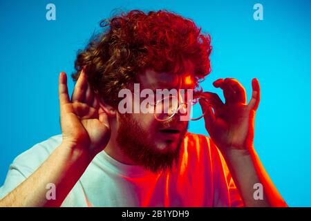 Attented. Handsome caucasian man's portrait isolated on orange studio ...