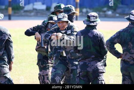 In-service policemen pointing their service weapon while on maneuver ...