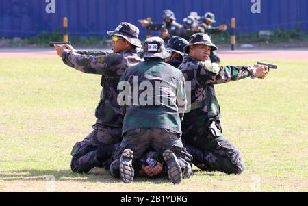 In-service policemen pointing their service firearm during VIP Security ...