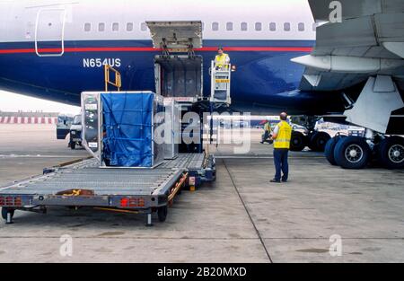 Baggage handlers (fleet service clerks) loading an airplane Stock Photo ...