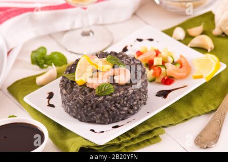 Squid ink risotto Stock Photo - Alamy
