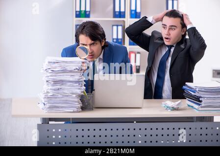 The two male colleagues unhappy with excessive work Stock Photo - Alamy