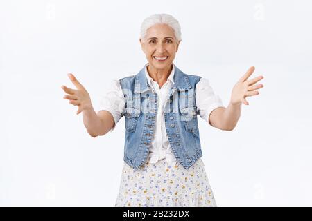 Mature old granny grandmother spread hands and give hug to you ...