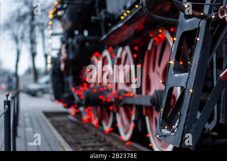 green christmas train with red wheels on a white background. front view ...