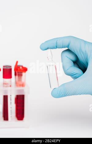 Test tubes with blood samples near cotton swabs on blue background ...