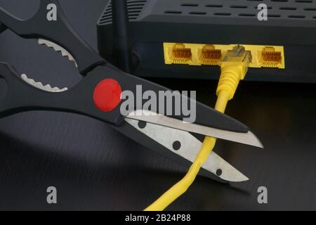 Cutting the network cable with scissors connected to the communication ...