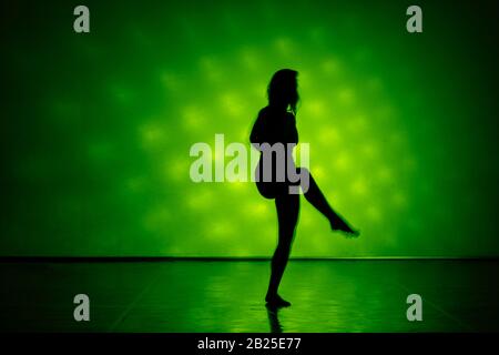 Slender athletic woman performing modern style dance moves Stock Photo ...
