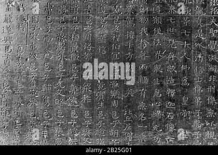 Chinese characters engraved on ancient stone Stock Photo - Alamy