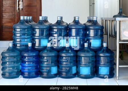 Plastic bottles with purified water stacked up in front of a grocery ...