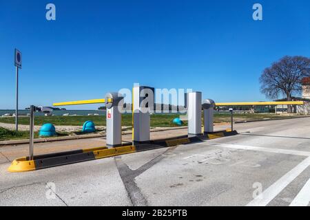 Parking lot entrance with barrier ramp Stock Photo - Alamy