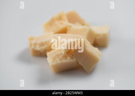 Parmesan cheese chunks on white background, shallow focus Stock Photo ...