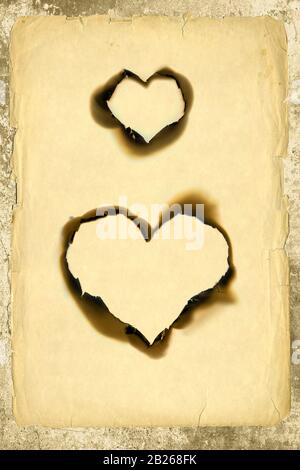 Heart shape hole burnt paper on Arabic words Stock Photo - Alamy