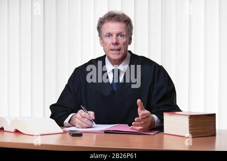A male lawyer talking in a courtroom Stock Photo - Alamy