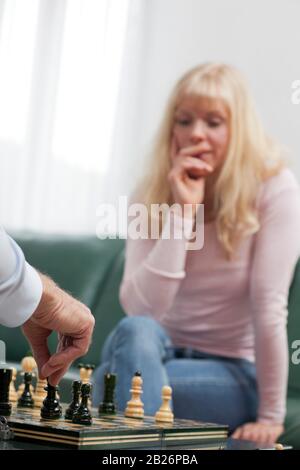 Cute man and woman playing game by joysticks on sofa at home Stock ...