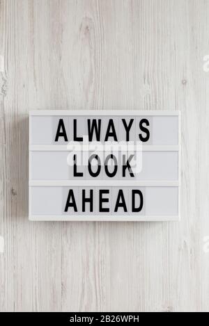 'Always look ahead' words on a modern board, clipboard with blank sheet ...