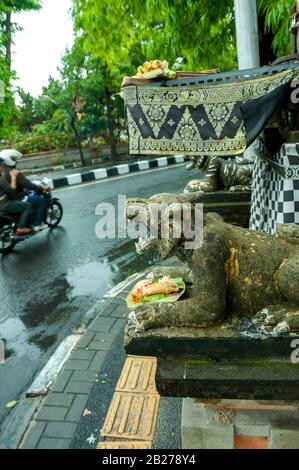 Carved Tiger statues, or Dvarapala, guarding a small Hindu shrine at a ...