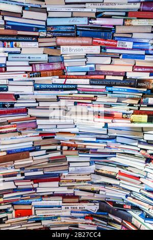 Tall stack of books, book tower with blank black covers but top book is ...