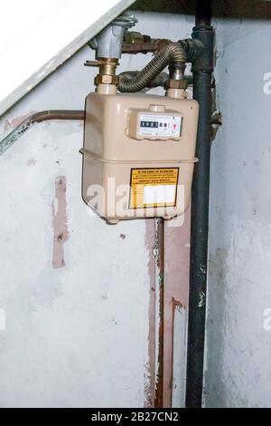 Mains gas meter mounted inside a cabinet built into the outside brick ...