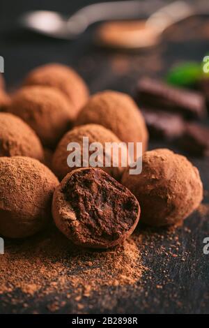 Cut black truffles on dark brown vintage background. Selective focus ...