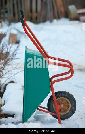 Metal garden wheelbarrow in the snow in winter Stock Photo - Alamy