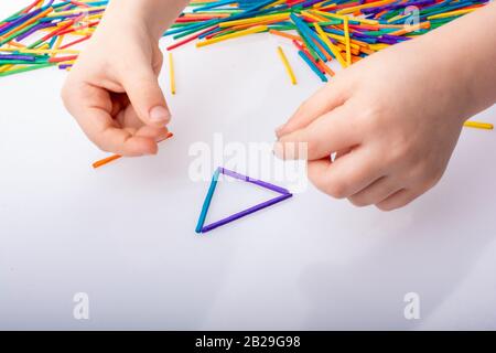 Kid making triangle shape on as creative concept Stock Photo - Alamy