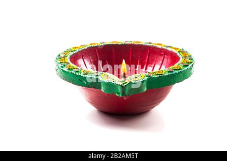 Diwali oil lamp - Diya lamp lit on colorful Rangoli Stock Photo - Alamy