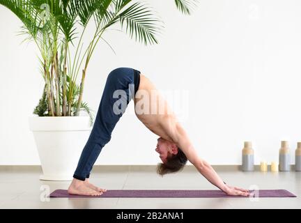 yoga exercise on the mat,downward facing shvanasana Stock Photo - Alamy